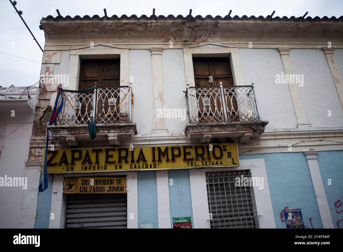 Dilapidated building in an Andean city. The building's facade is a mix ...