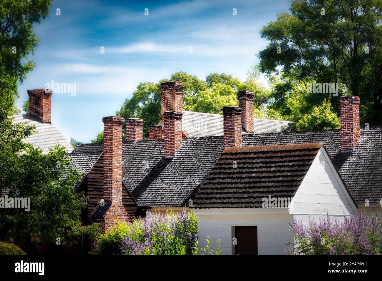 The summer sun shines on the rooftops and red brick chimneys in the ...
