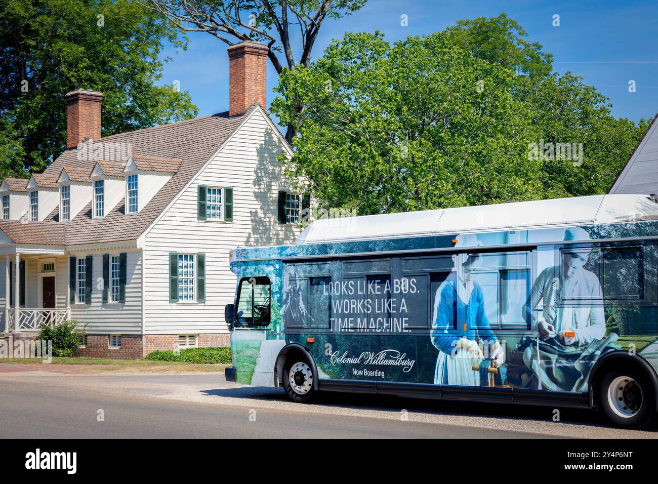 A city bus arrives at a stop near the historic district of Colonial ...