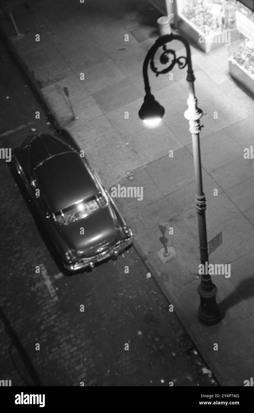 A car illuminated by a New York City street light at night C. 1952 ...