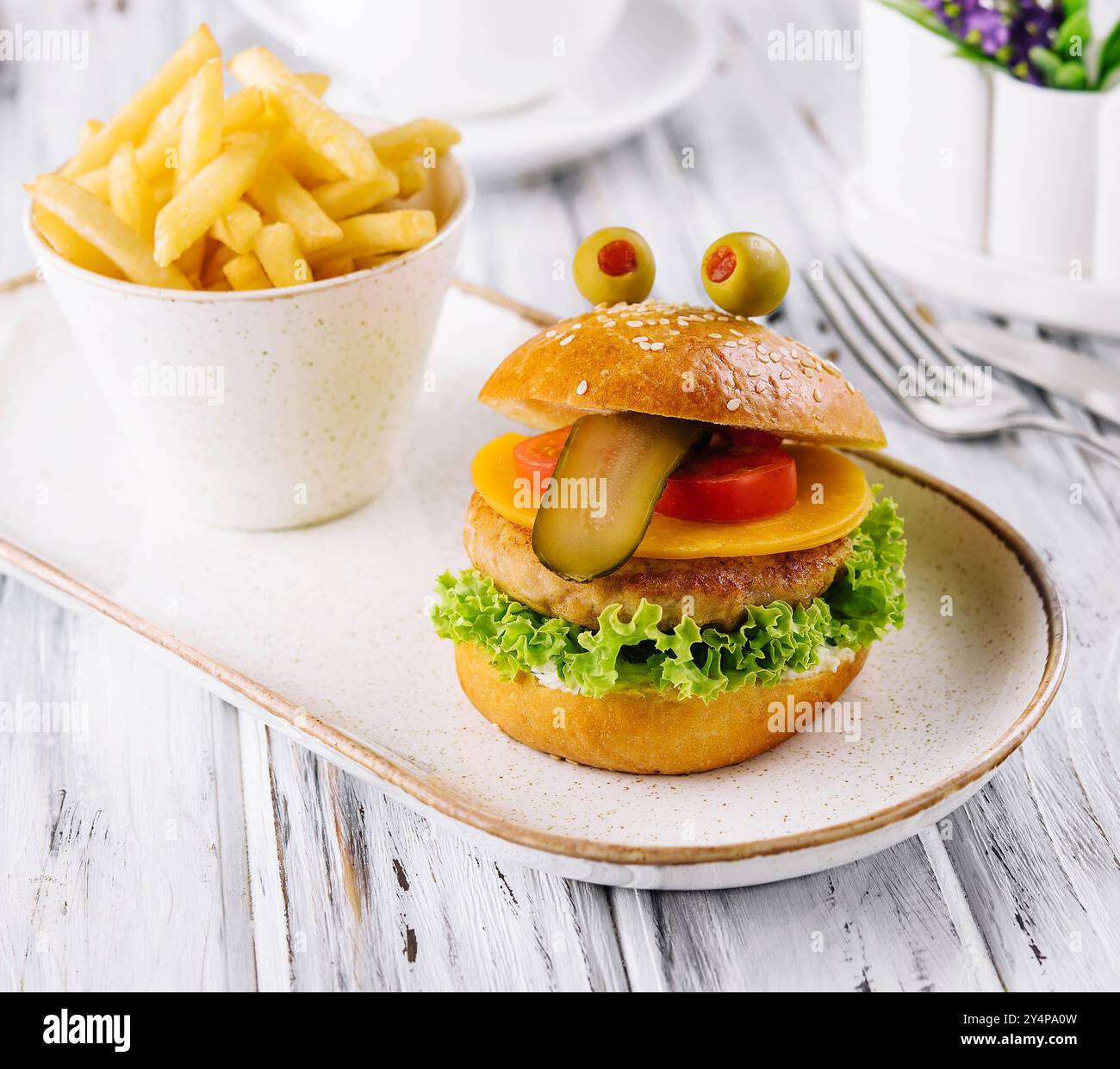 mini burger shows tongue. The concept of a favorite children's burger ...