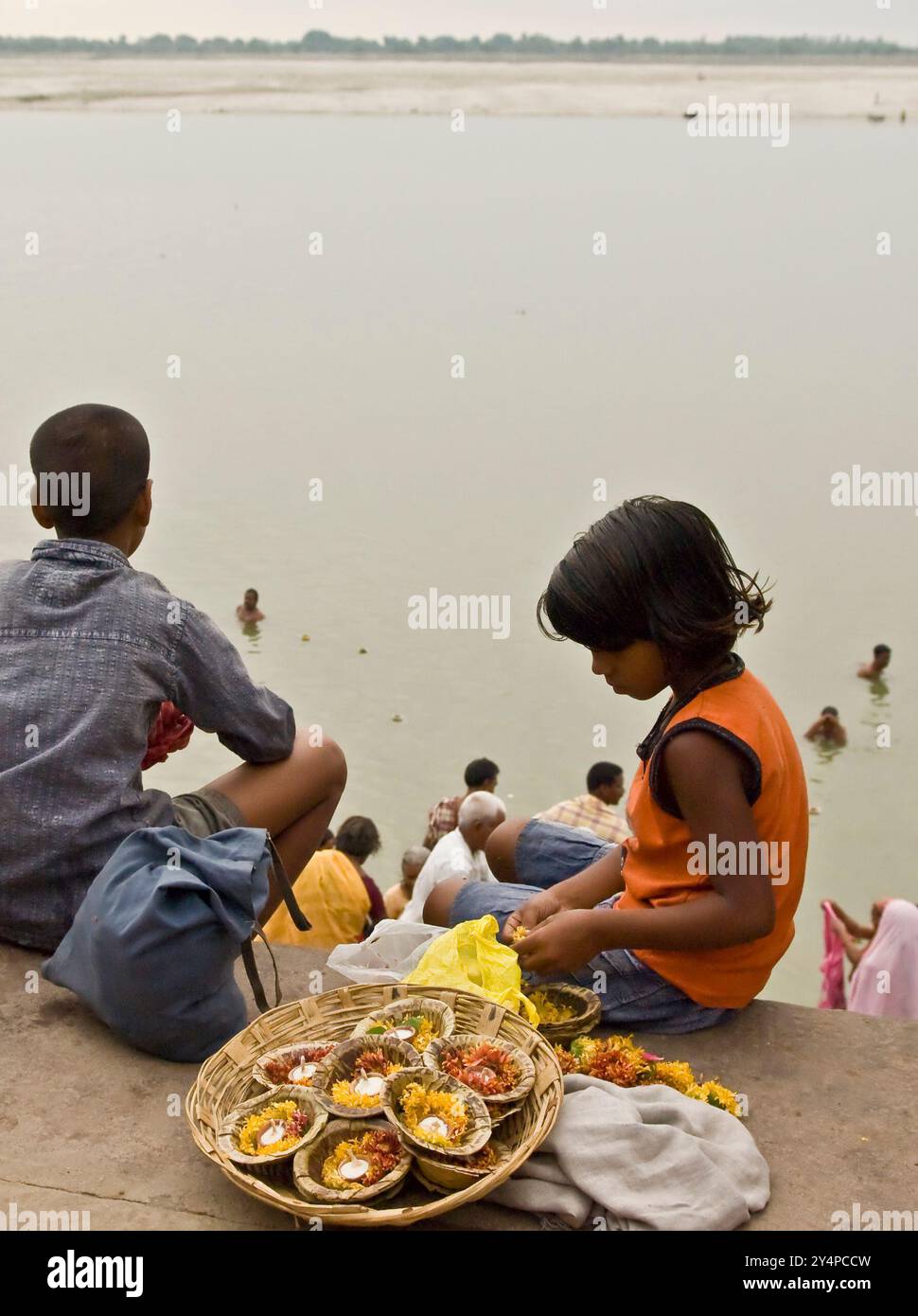 Monsoon rains and pilgrims and cremation rituals by the River Ganges ...