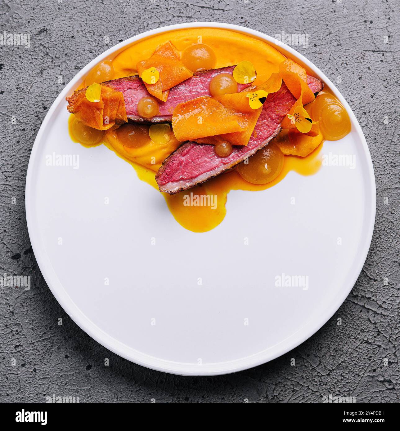 Exquisite serving juicy duck tenderloin with carrot puree Stock Photo ...