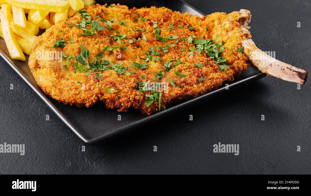 Fried wiener schnitzel from veal topside with french fries Stock Photo ...