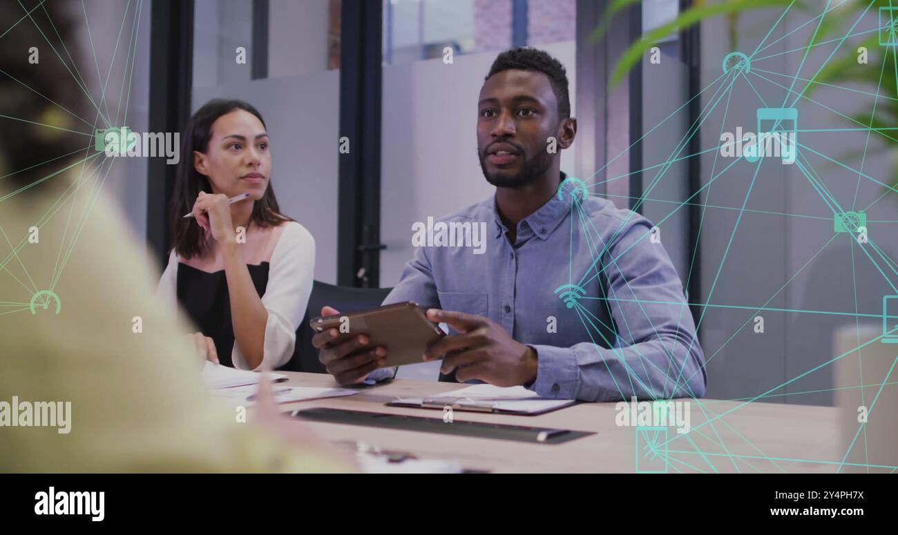 Image of network of connections with icons over diverse business people ...