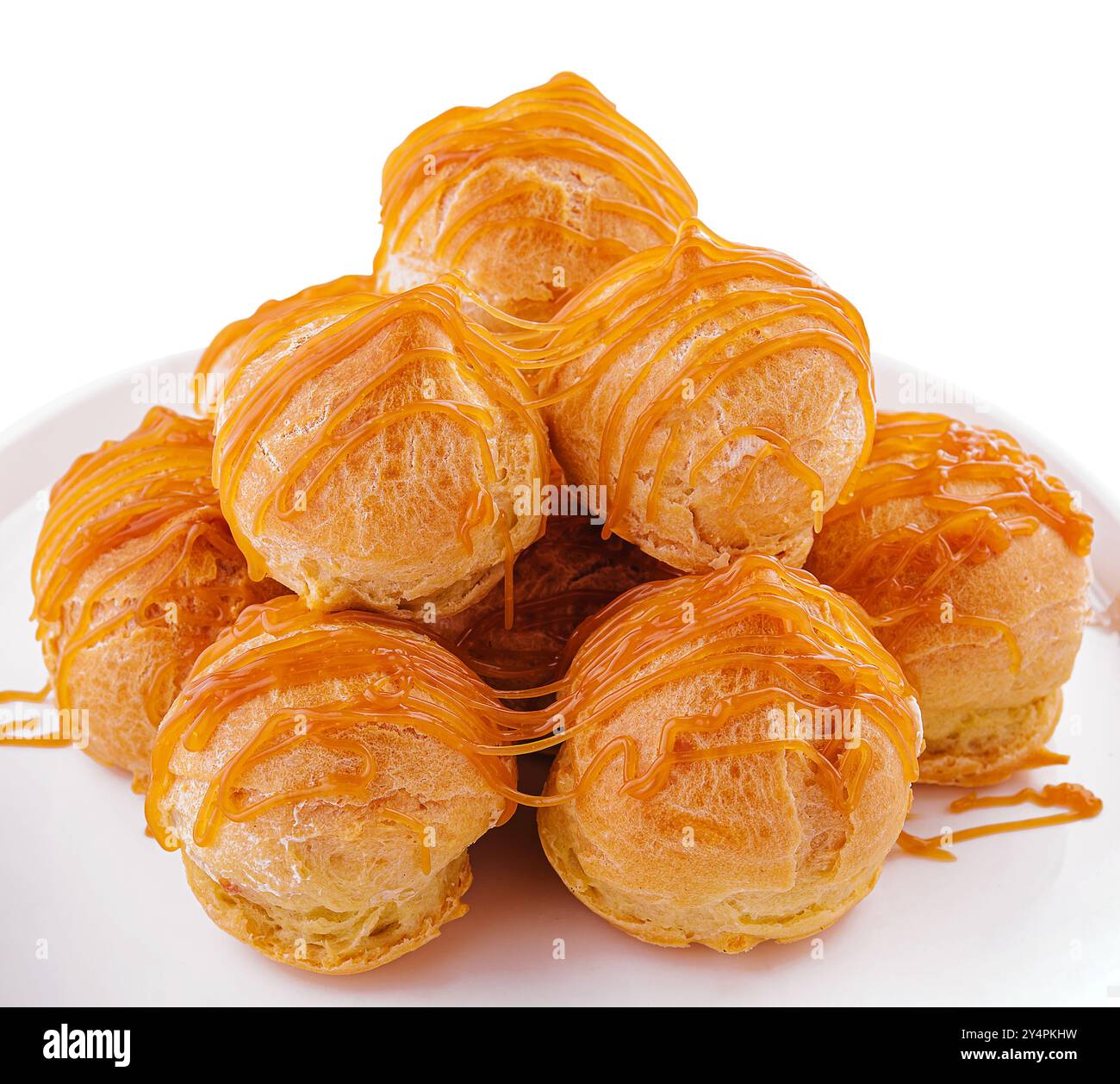Tasty round eclairs with cream on white background Stock Photo - Alamy