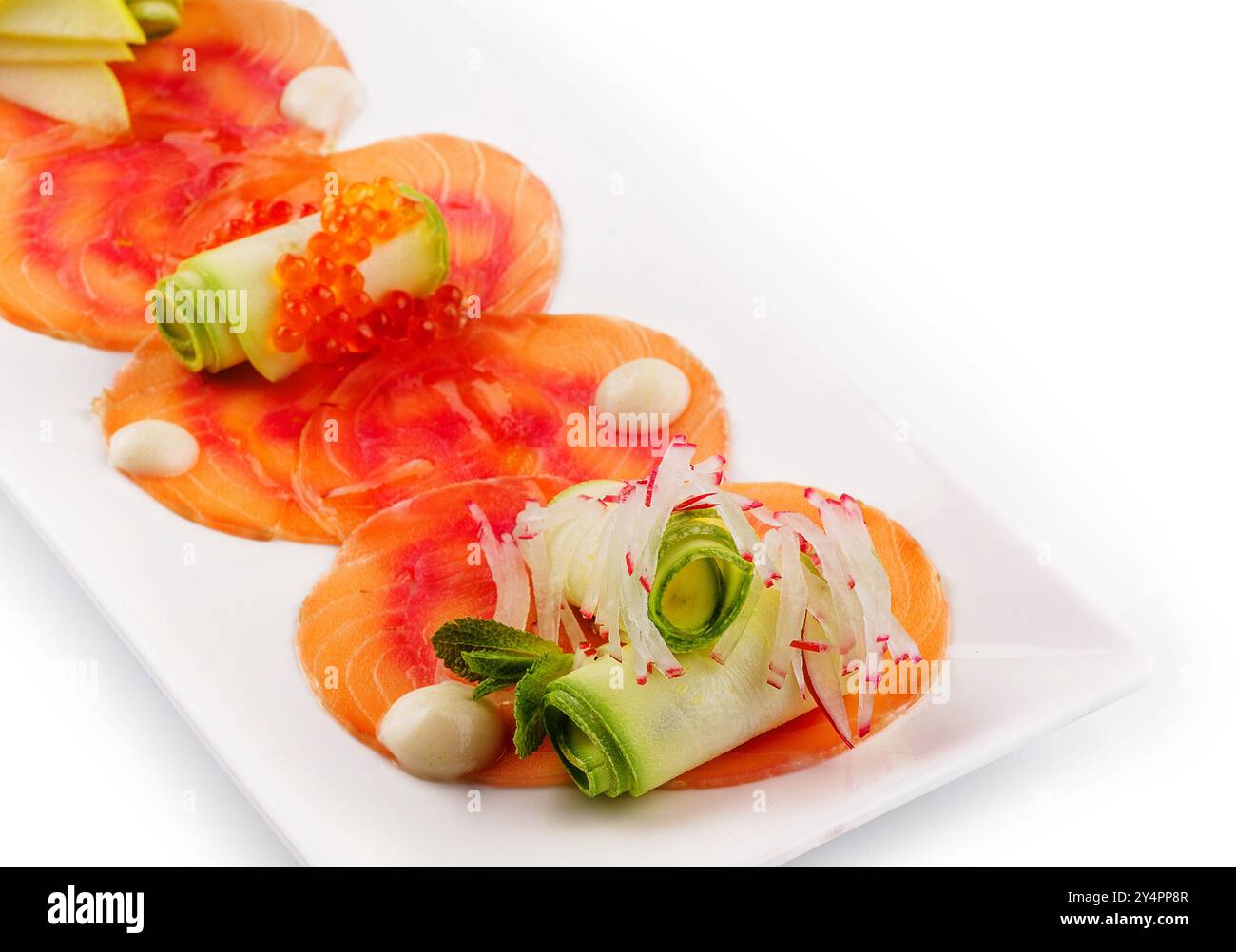 Smoked salmon fillet sliced and decorated with red caviar with zucchini ...