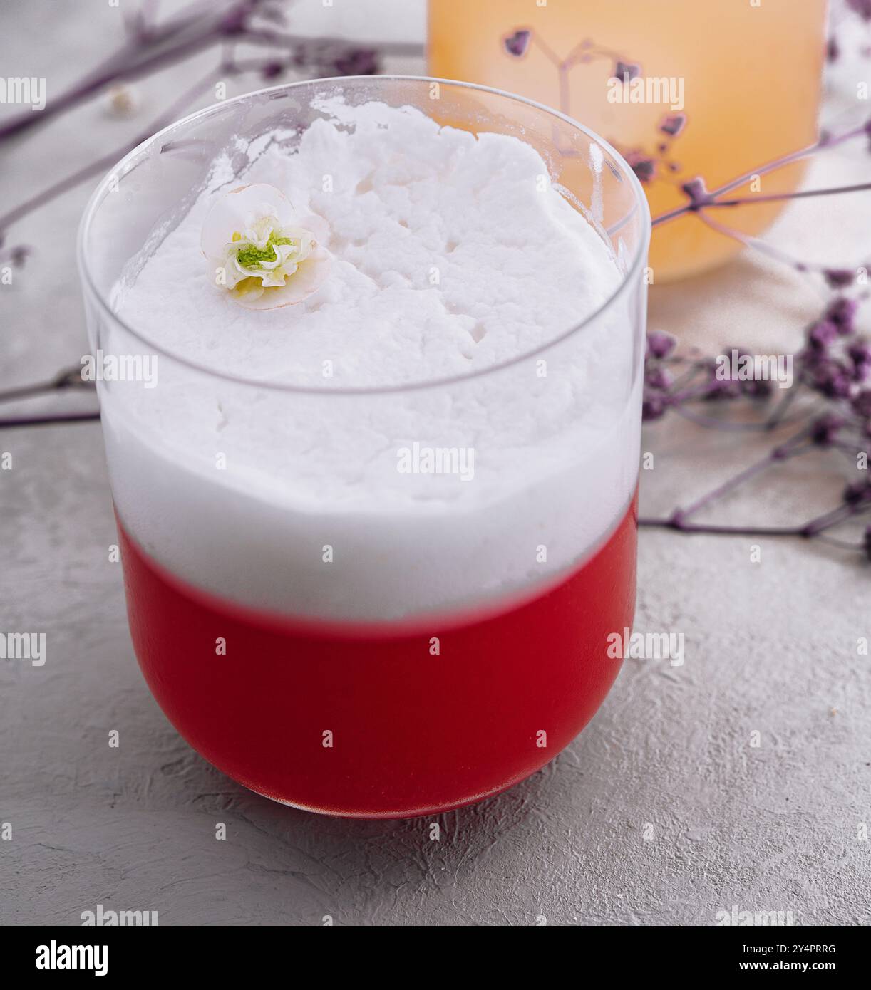 red cocktail with a white foam on top Stock Photo - Alamy