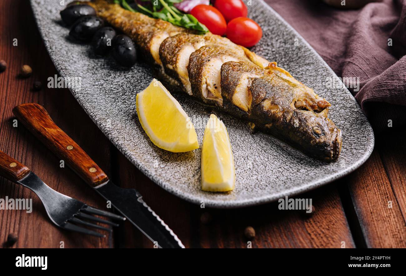 Fish dish - roast trout and vegetables Stock Photo - Alamy