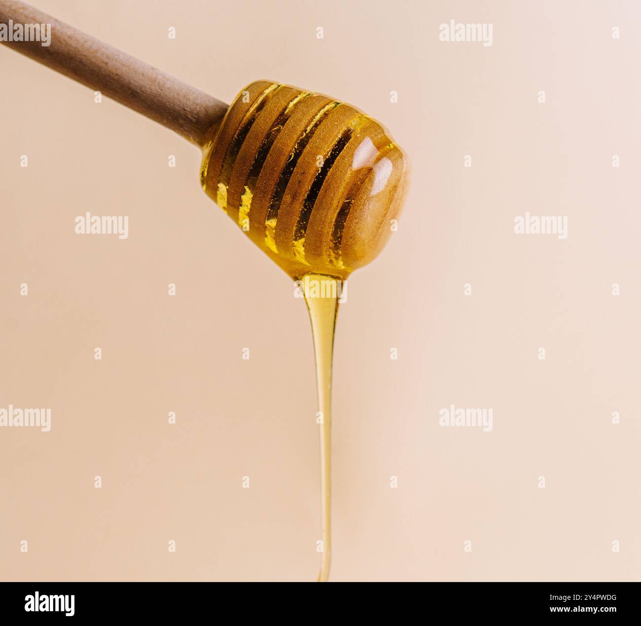 Liquid Gold: Honey Dripping from Dipper Stock Photo - Alamy