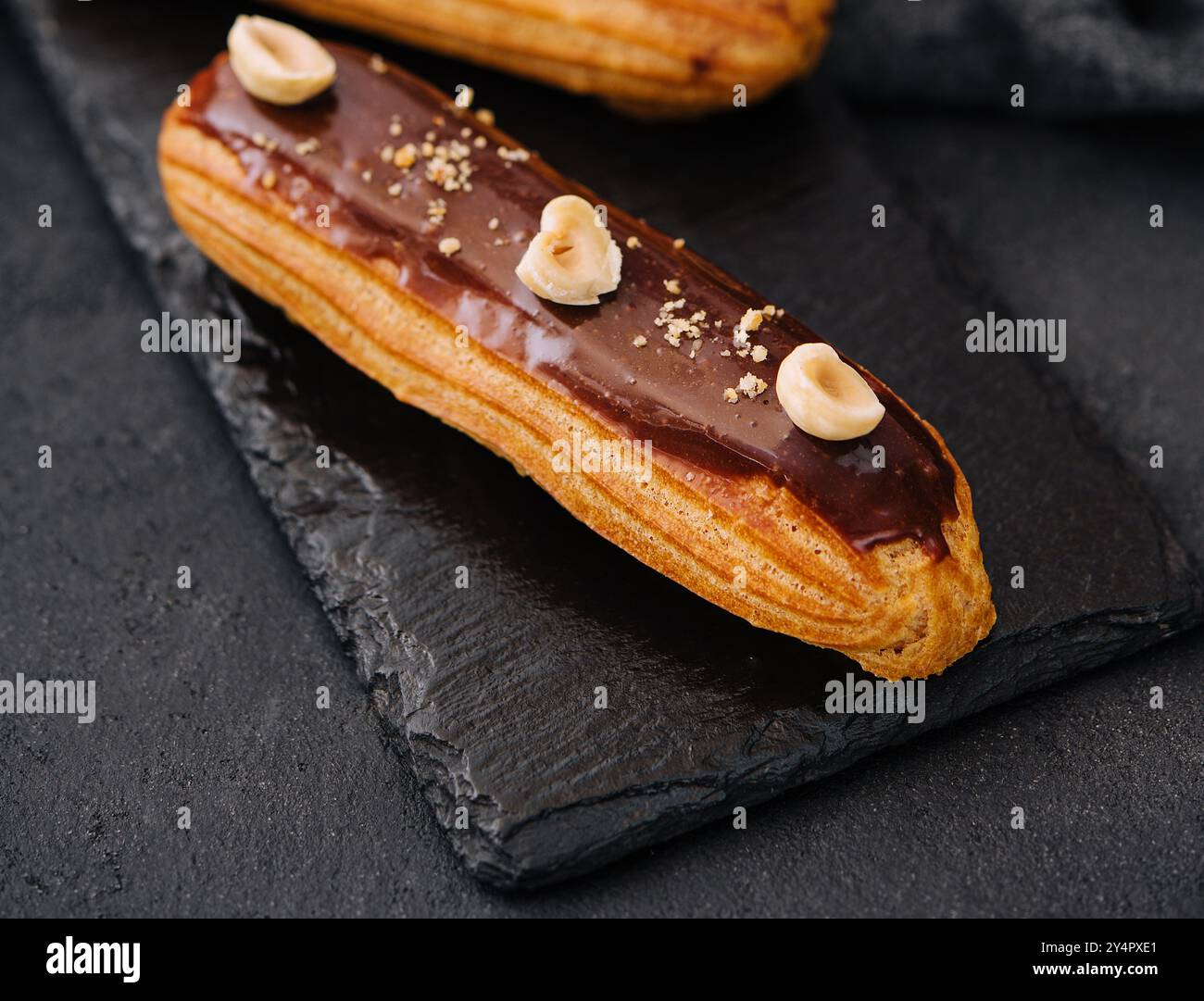 french eclairs with chocolate and hazelnuts Stock Photo - Alamy