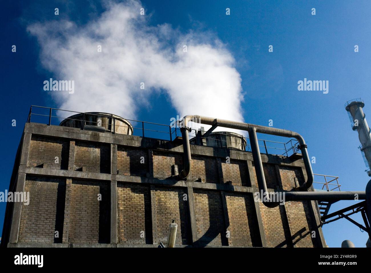 Steam rises from cooling towers at a chemical factory in Huelva ...