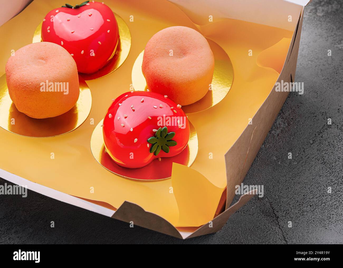 fruit-shaped mousse cakes strawberry and peach in a box Stock Photo - Alamy