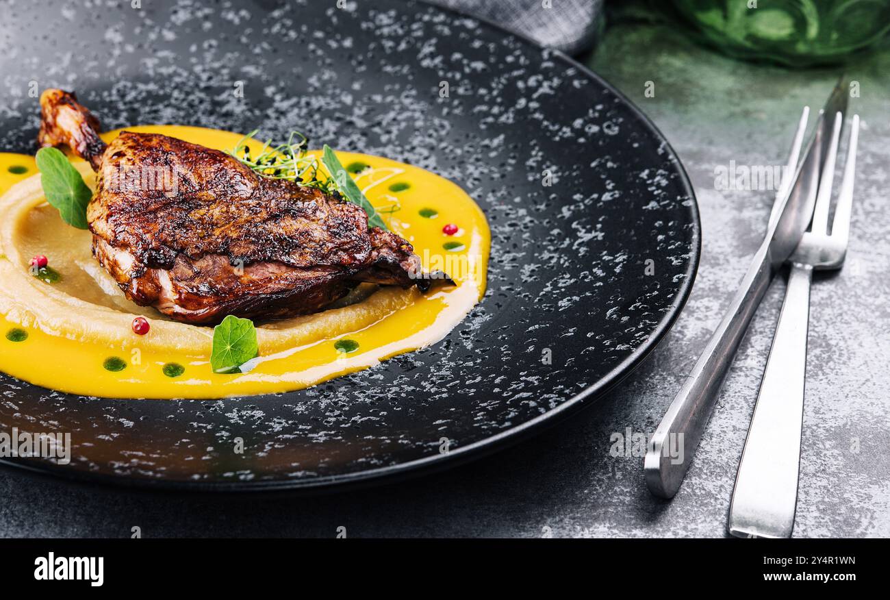 Roast duck leg with mashed green vegetables Stock Photo - Alamy