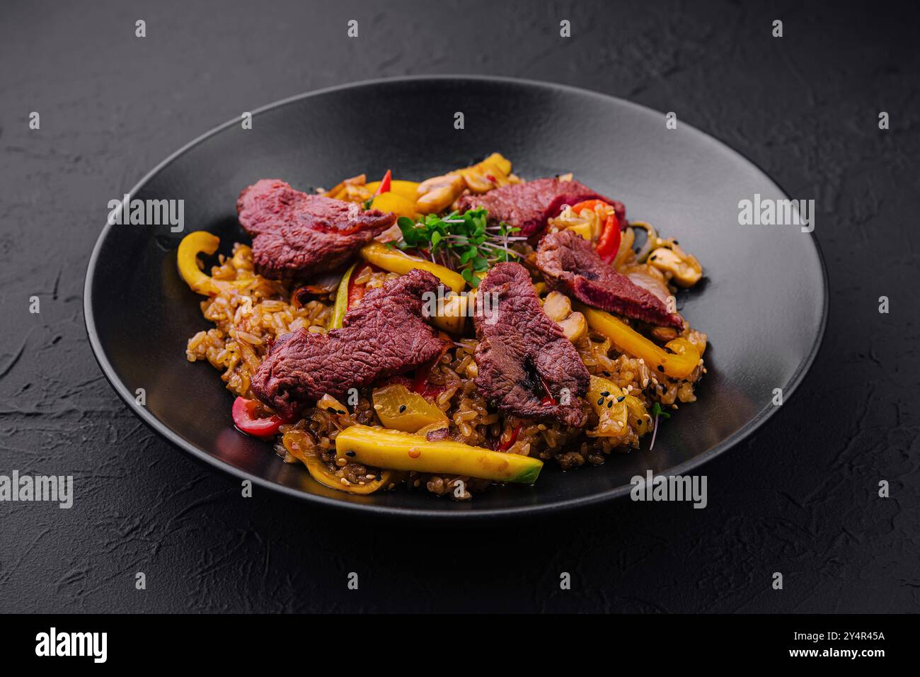 Chinese fried rice with beef on black plate Stock Photo - Alamy