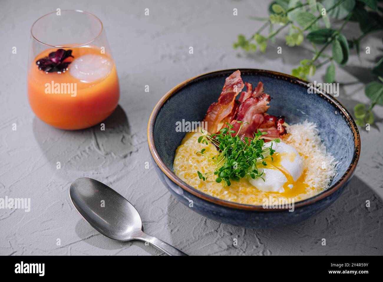 oatmeal porridge with poached egg and bacon Stock Photo - Alamy