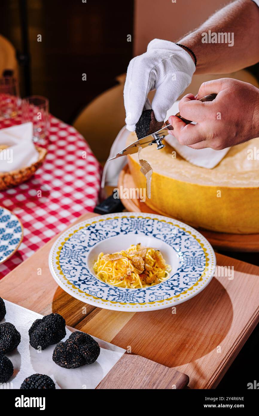 Chef Grating Truffle Shavings on Pasta with Parmesan Stock Photo - Alamy