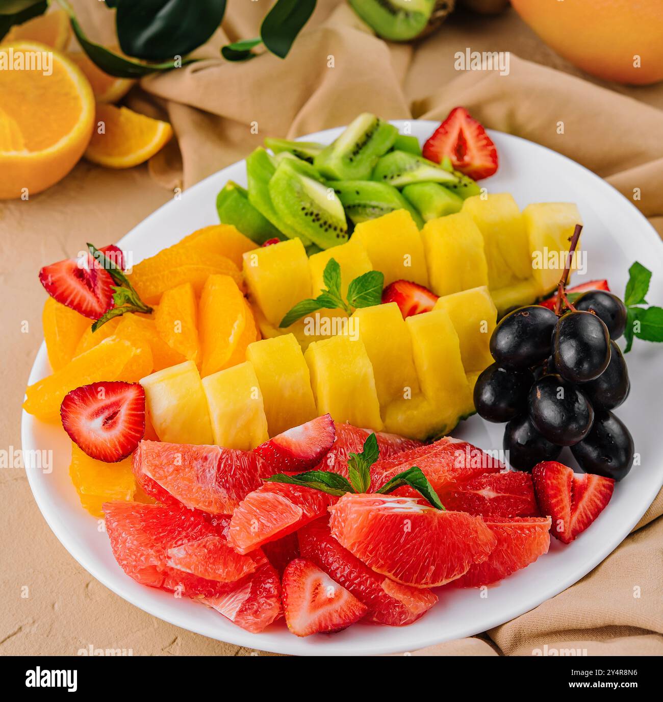 Assorted sliced tropical fruits on plate hi-res stock photography and ...