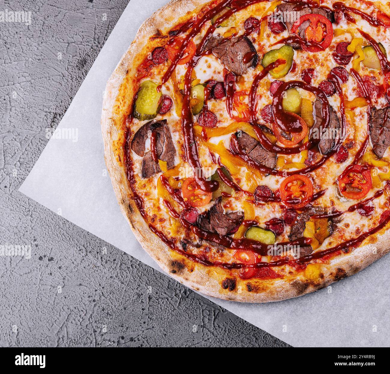 Italian pizza with sausage, meat and cucumbers Stock Photo - Alamy