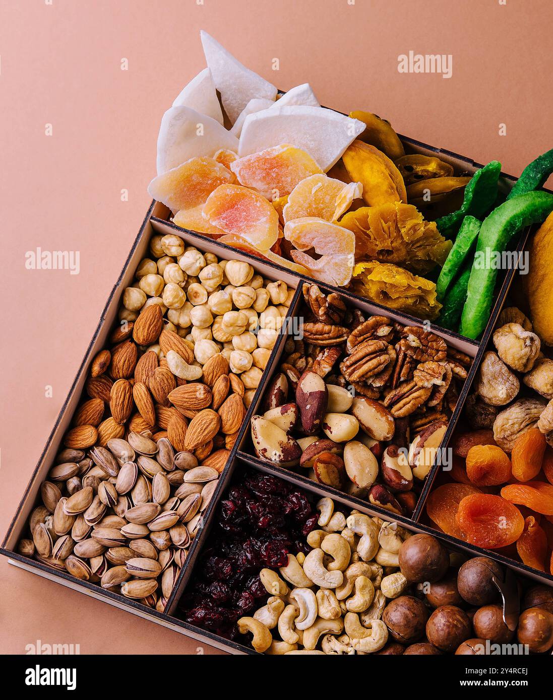 Assorted nuts and dried tropical fruits in a wooden box Stock Photo - Alamy