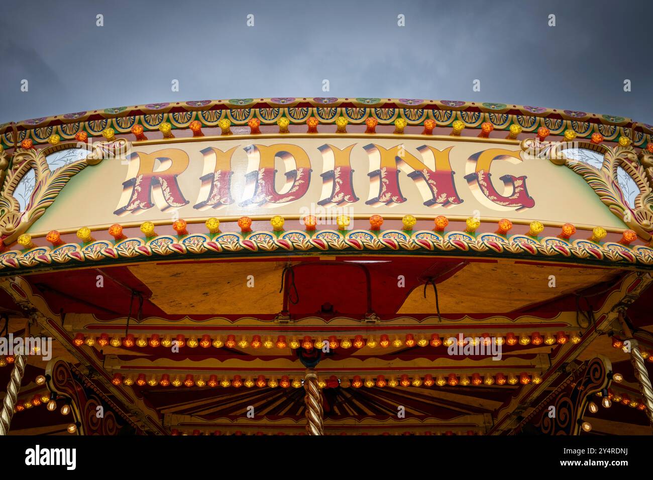 The painted sign on a steam fairground carousel close up, showing the ...