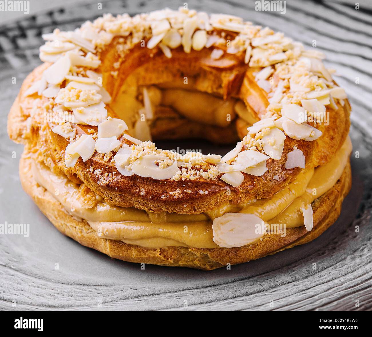 round cake with mendal and custard Stock Photo - Alamy