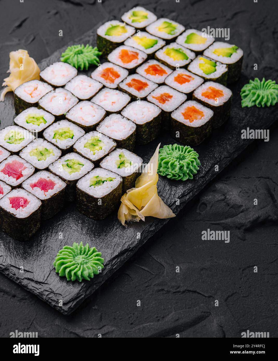 Maki sushi set served on black stone tray Stock Photo - Alamy