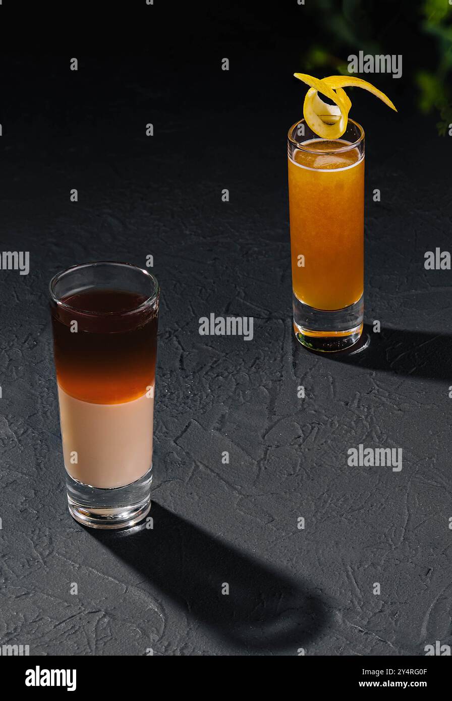 two different shots with alcoholic cocktails on dark stone Stock Photo ...