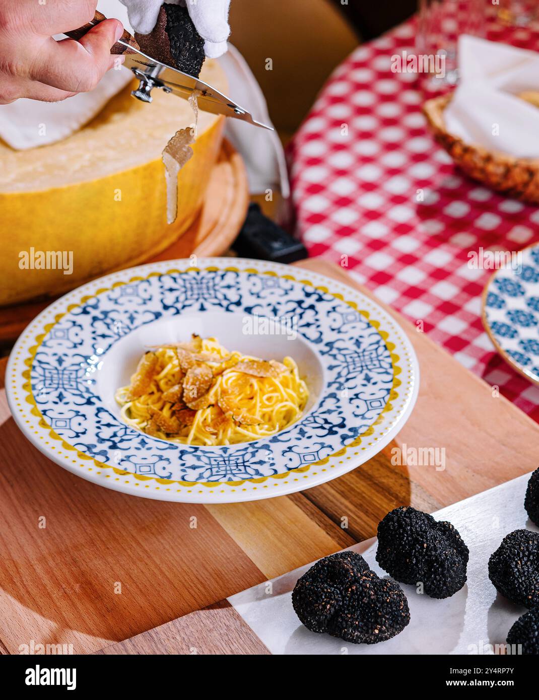 Chef Grating Truffle Shavings on Pasta with Parmesan Stock Photo - Alamy
