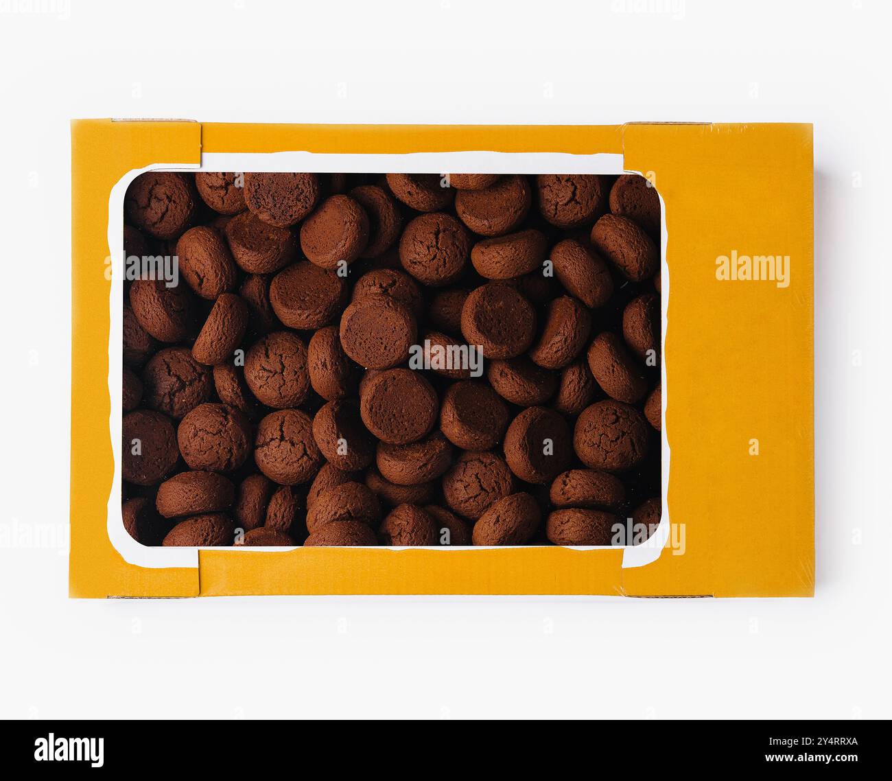 Top view of an open yellow box filled with round chocolate cookies on a ...