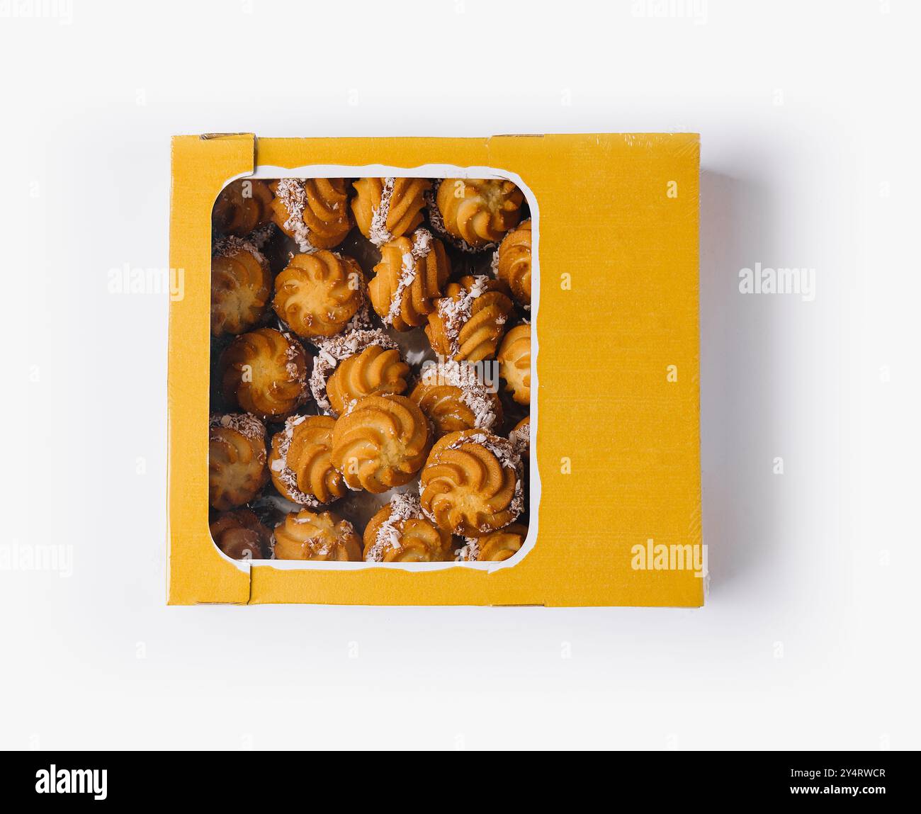 Top view of a yellow box filled with a variety of butter cookies ...