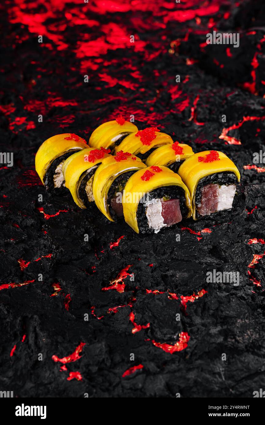 Artistic sushi presentation with a roll on a dramatic black and red ...