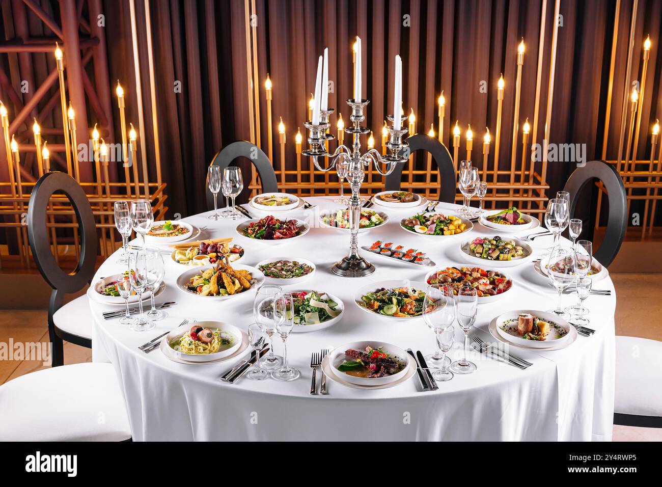 Luxurious dinner spread on a round white table in a posh restaurant ...