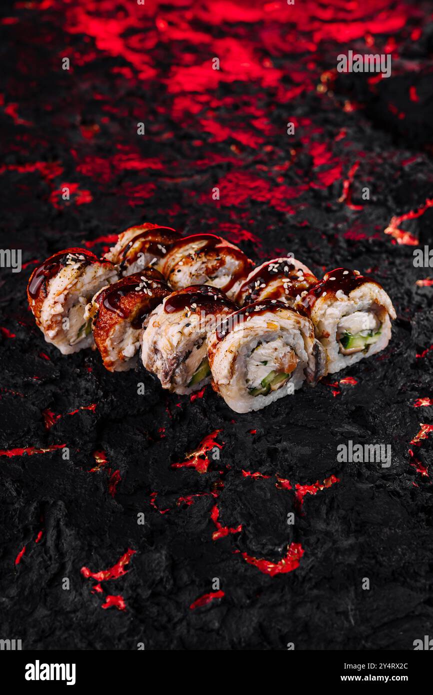 Creative sushi roll presentation on a fiery lava-like textured surface ...