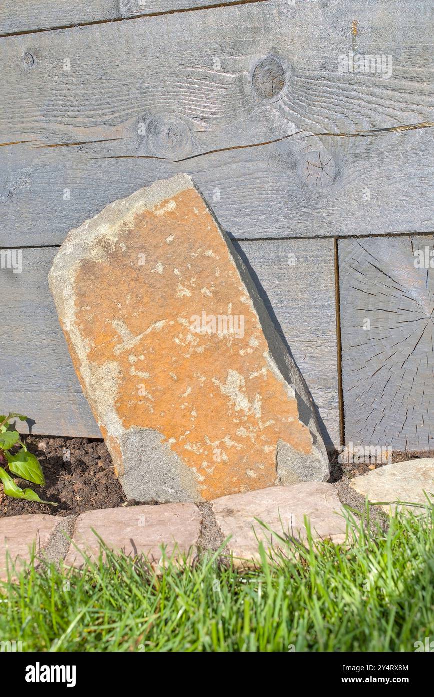 Piece of blue pennant sandstone against a grey painted raised timber ...