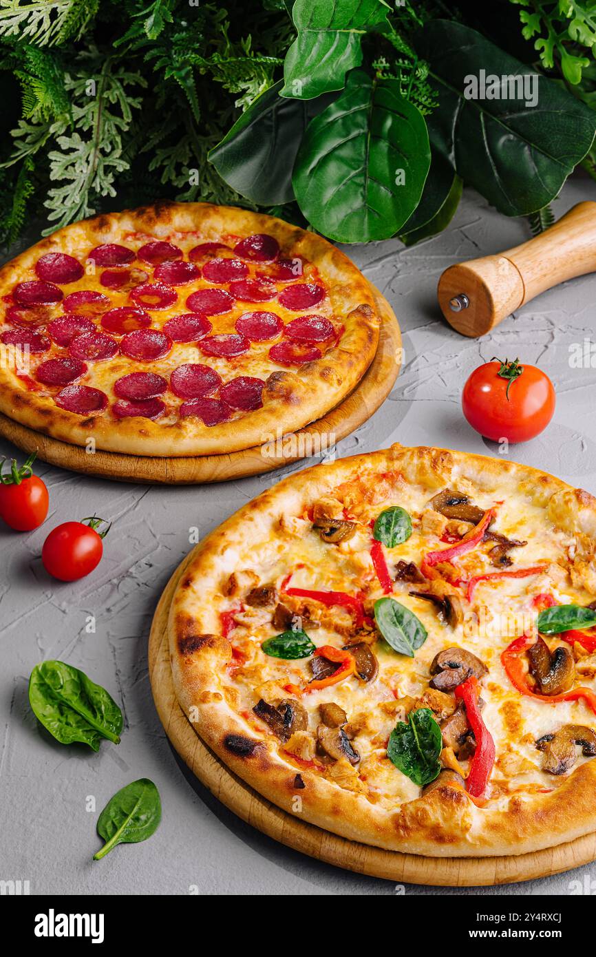 Two tasty pizzas with pepperoni and vegetables, fresh ingredients on a ...