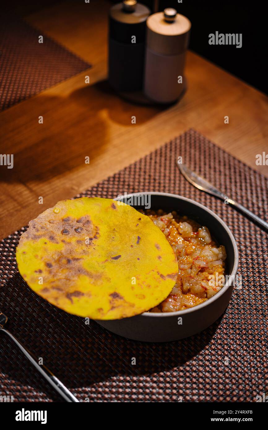 Rustic presentation of a classic indian dish featuring a fresh roti and ...