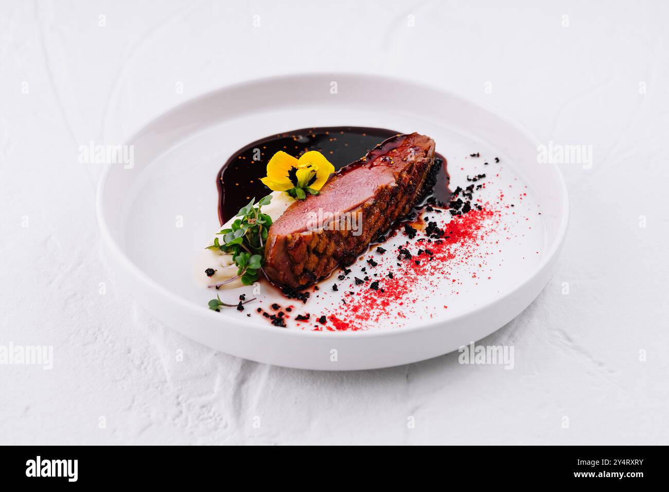 Elegant plated beef steak with a rich red wine sauce, garnished with ...