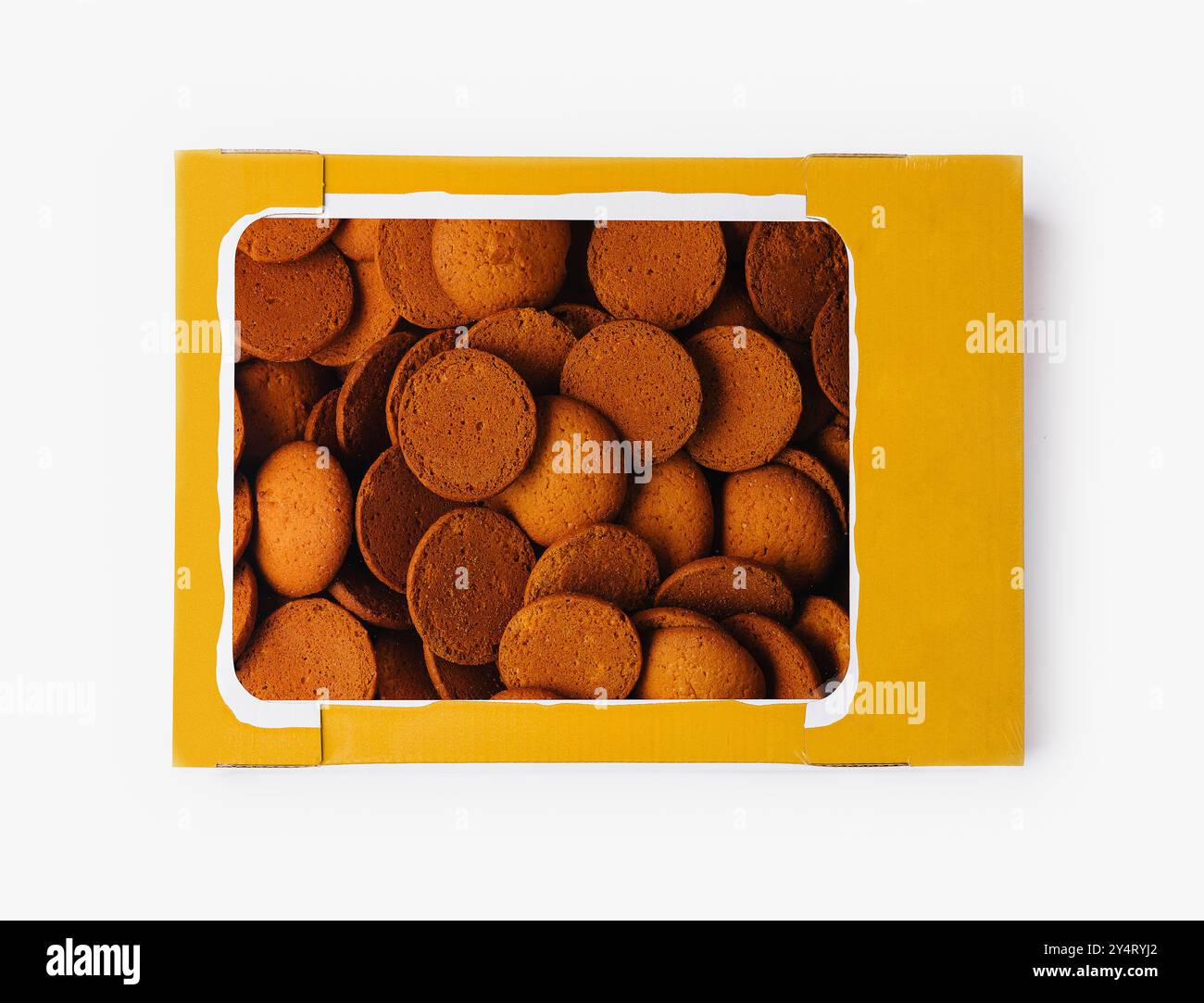 Top view of an open yellow box filled with homemade brown cookies ...