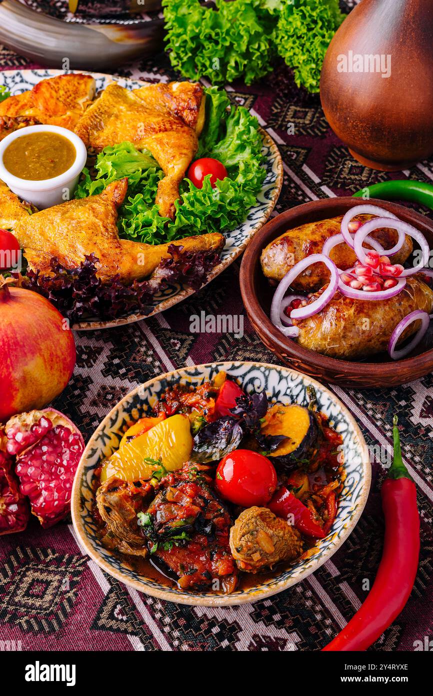 Colorful display of roasted chicken, vegetables, and sauce arranged ...