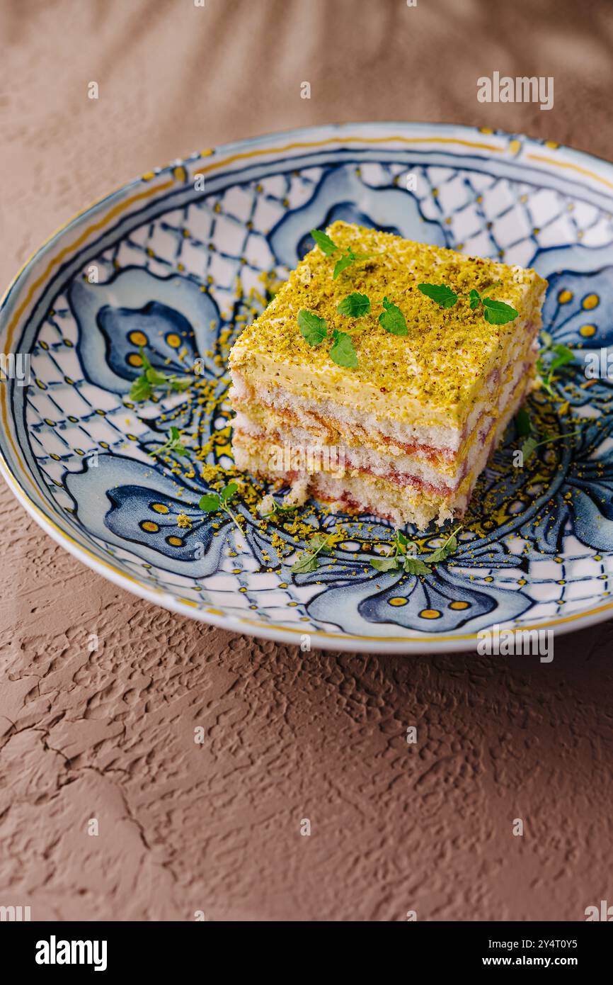 Slice of persian love cake garnished with pistachios on an ornate plate ...