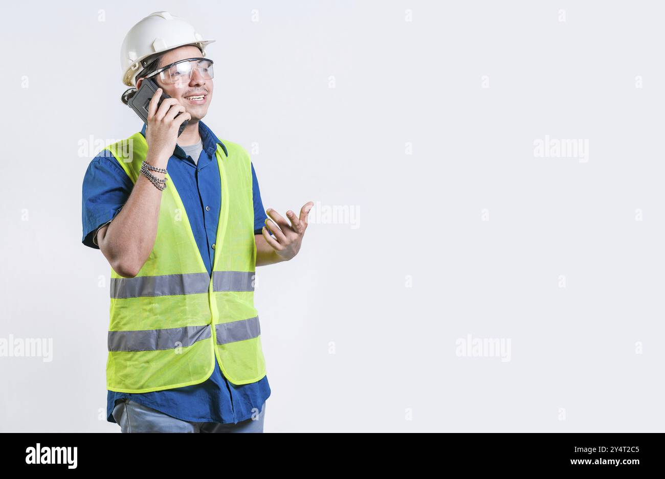Civil engineer talking phone isolated. Young latin engineer calling on ...