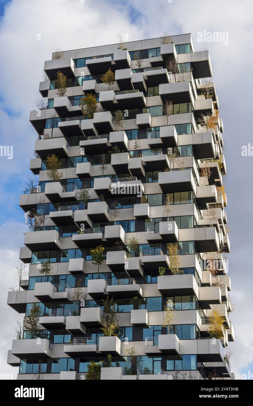 High-rise residential building with integrated planted trees, housing ...