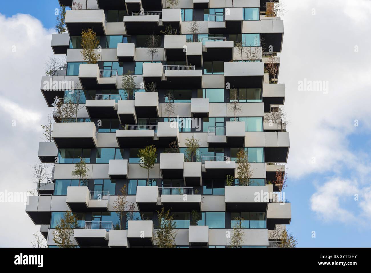 High-rise residential building with integrated planted trees, housing ...