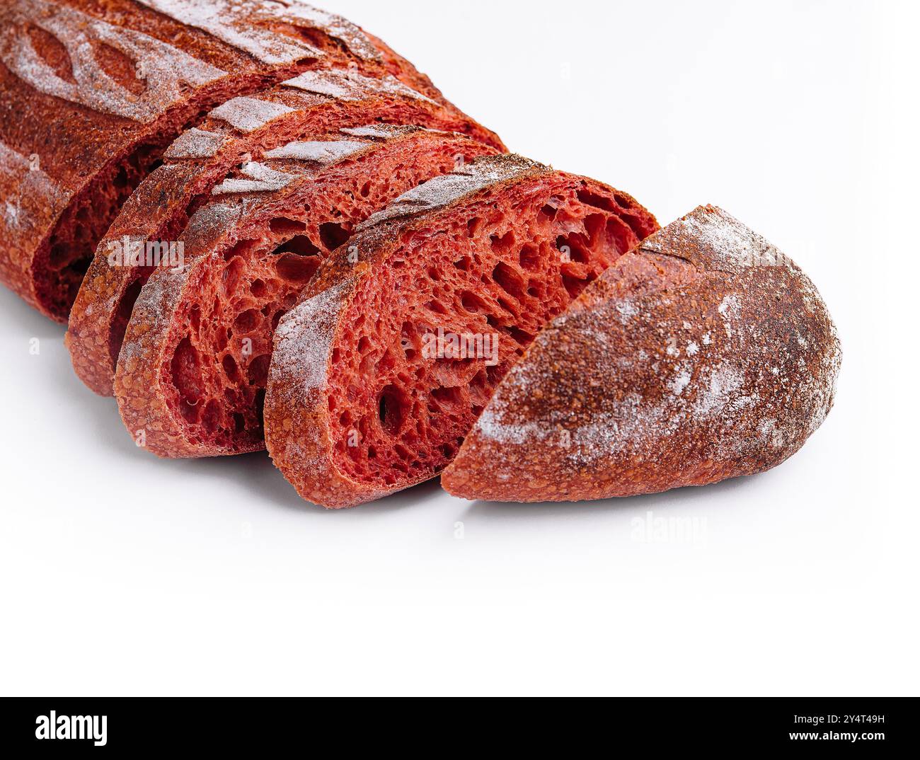 Vibrant sliced loaf of beetroot bread isolated on a white background, showcasing its unique ...