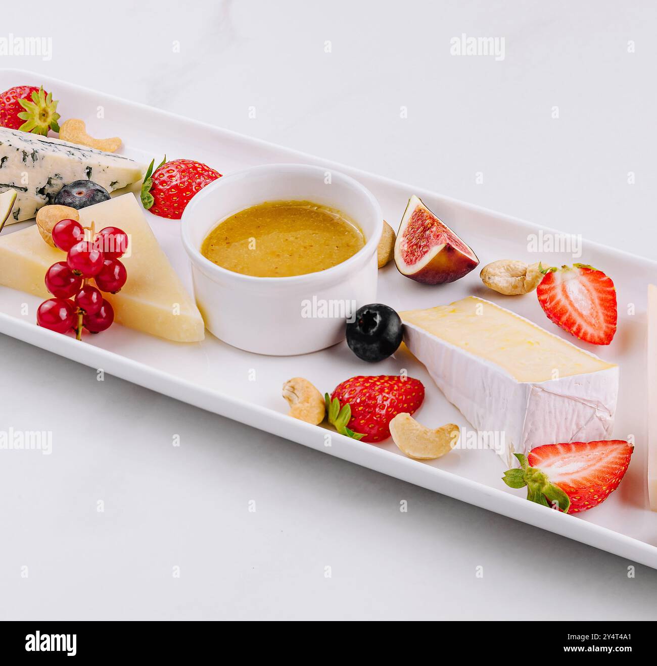 Elegant cheese selection served with fresh berries, figs, and dipping ...