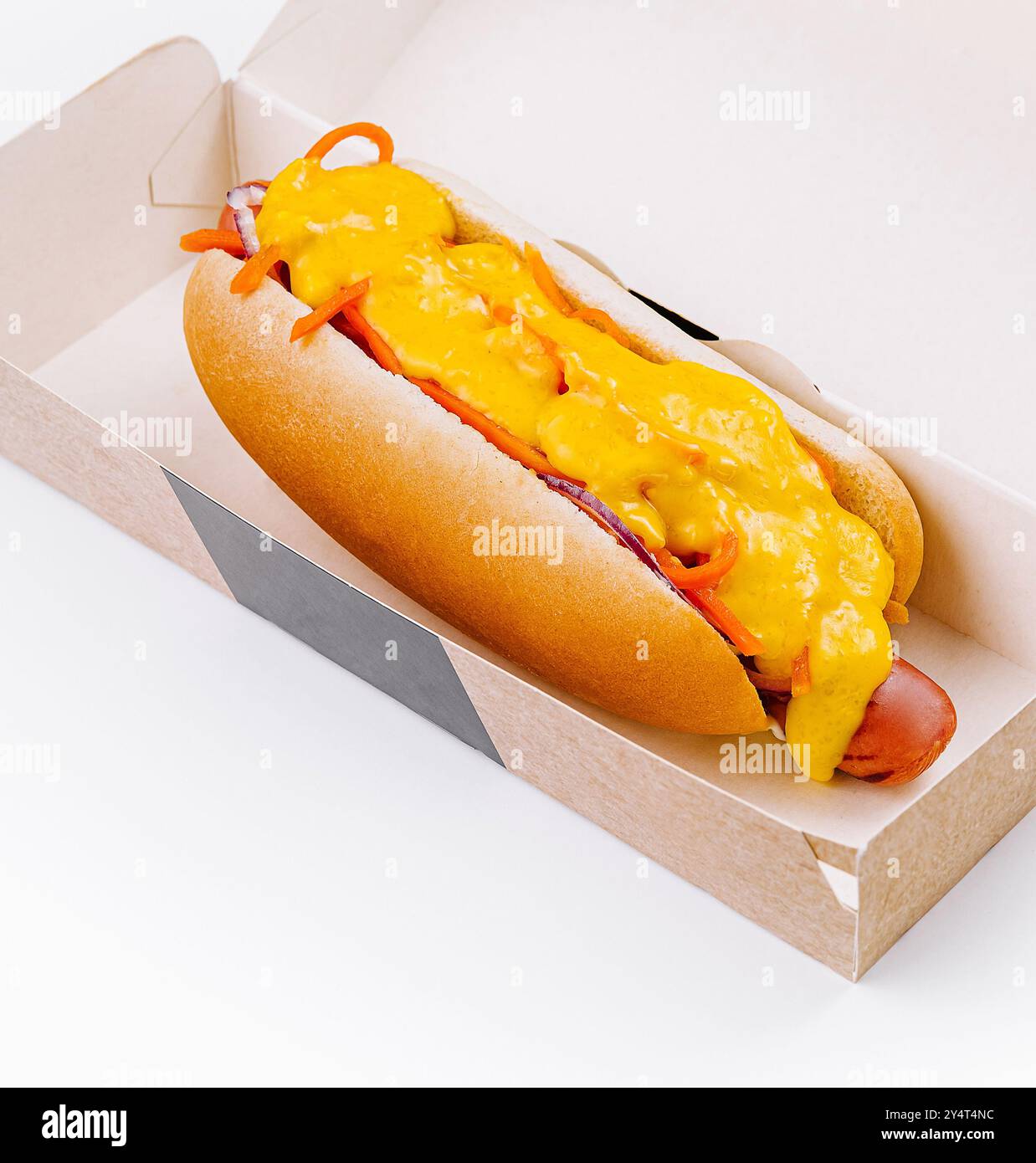 Delicious hot dog with melted cheese and ketchup in a cardboard box ...