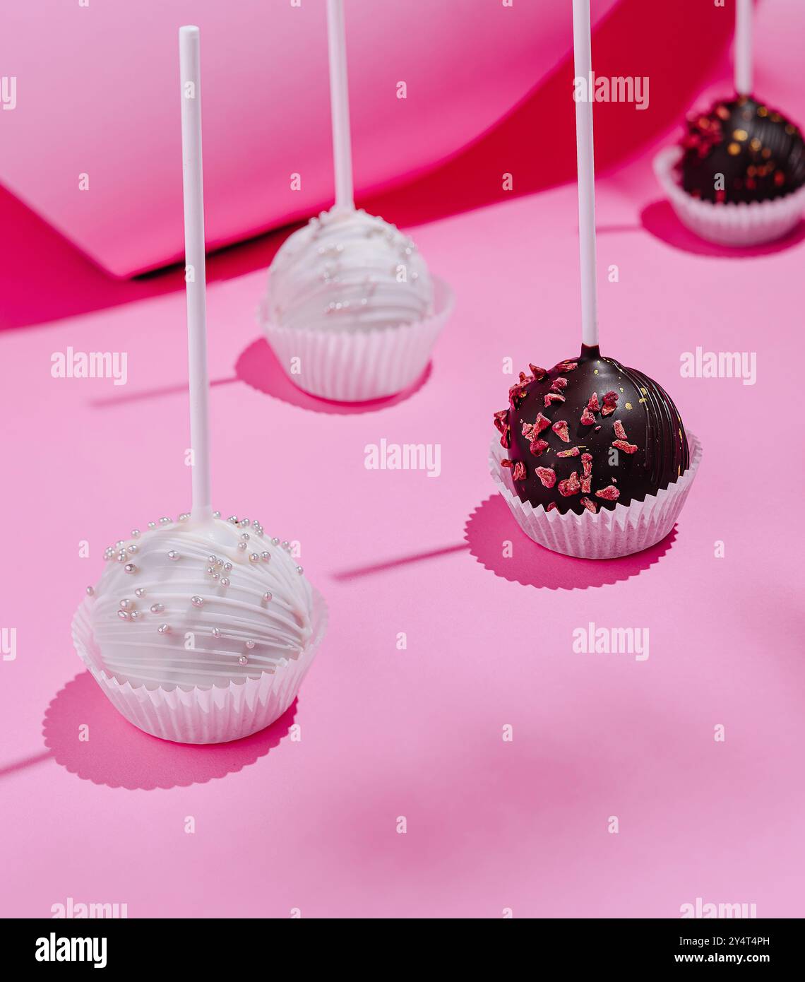 Elegant chocolate and white cake pops with decorative sprinkles ...