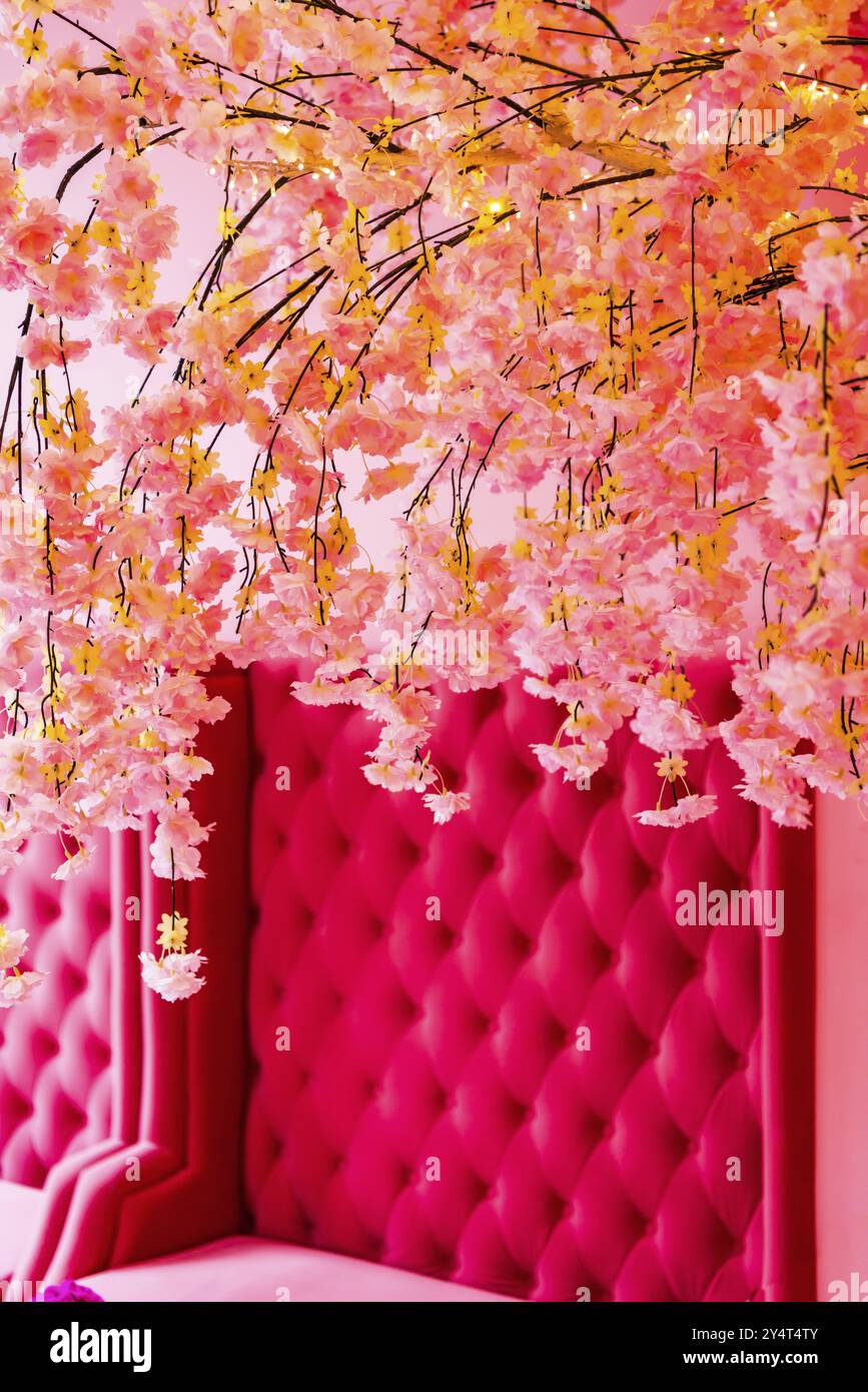 Vintage decoration in pink with plush sofa as furnishing, flowers ...
