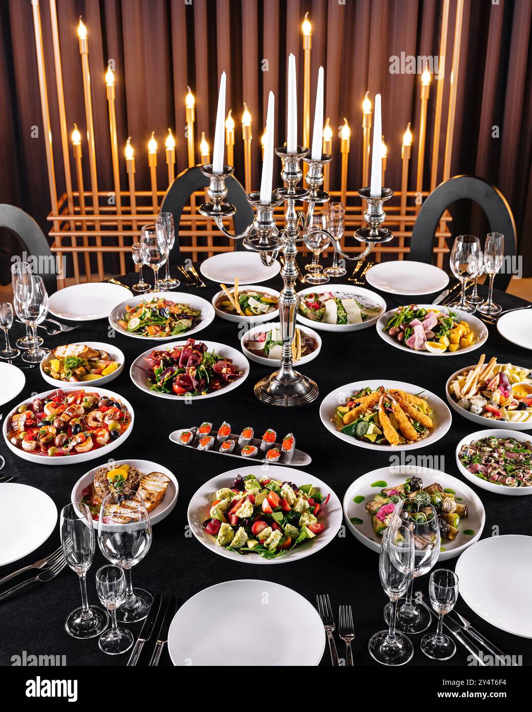 Luxurious dinner table setup with a candelabra and gourmet dishes Stock ...